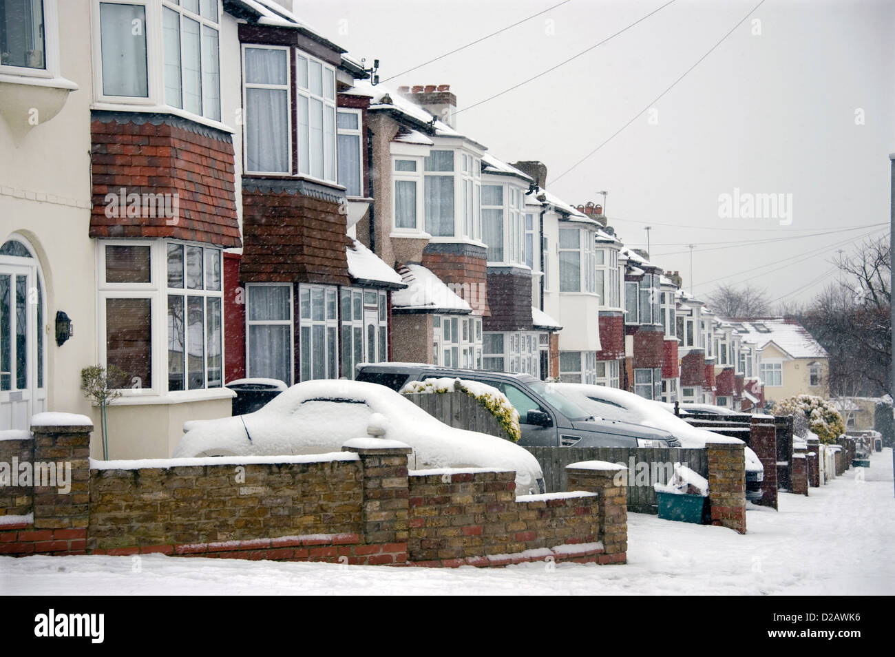 A snow covered street scene in a quite London Residential Street Stock ...