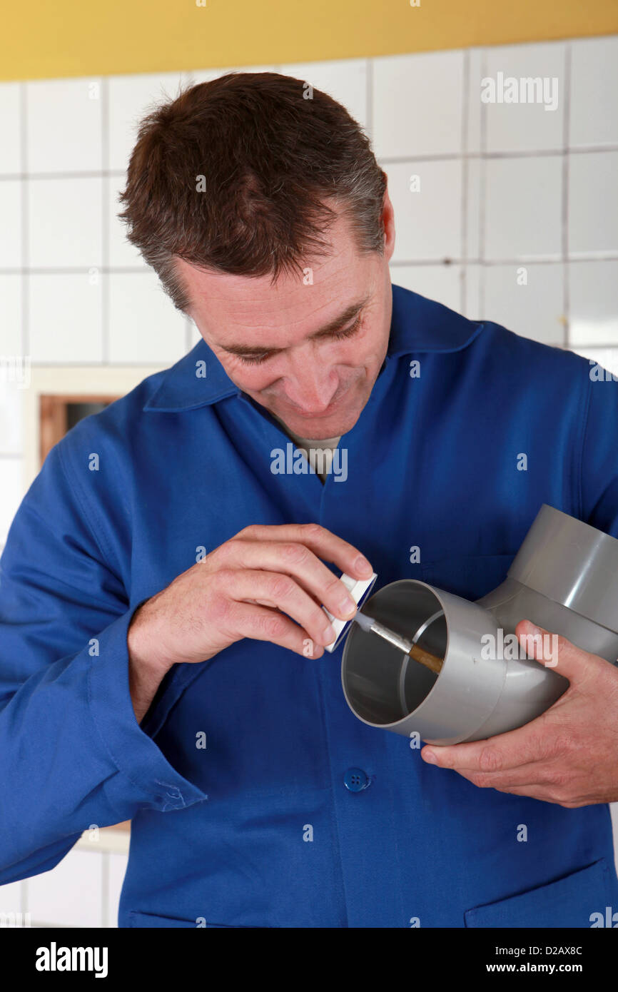 Plumber preparing plastic pipe Stock Photo - Alamy