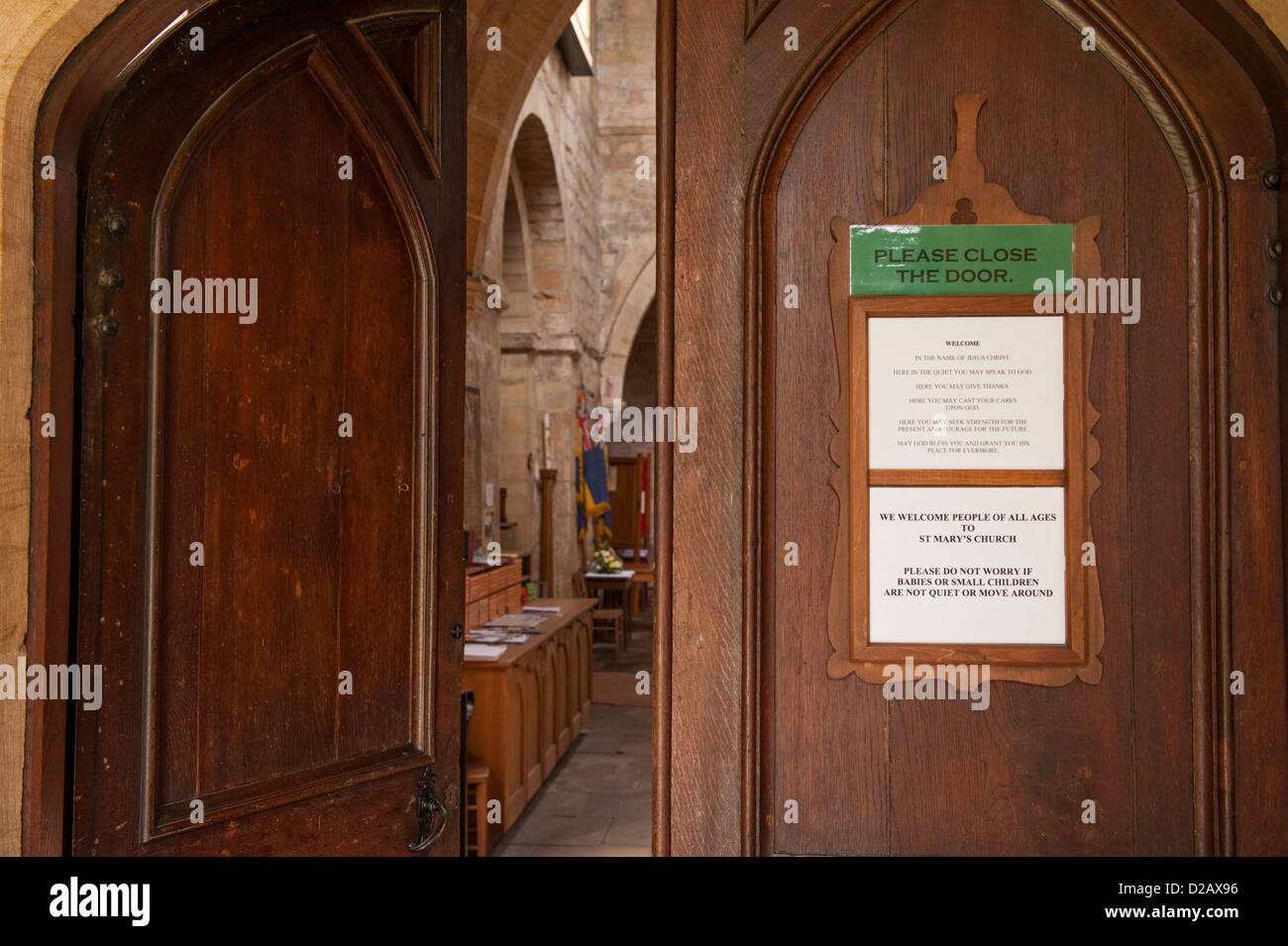 Close-up of welcome sign on wooden doors (1 open & one closed) from ...