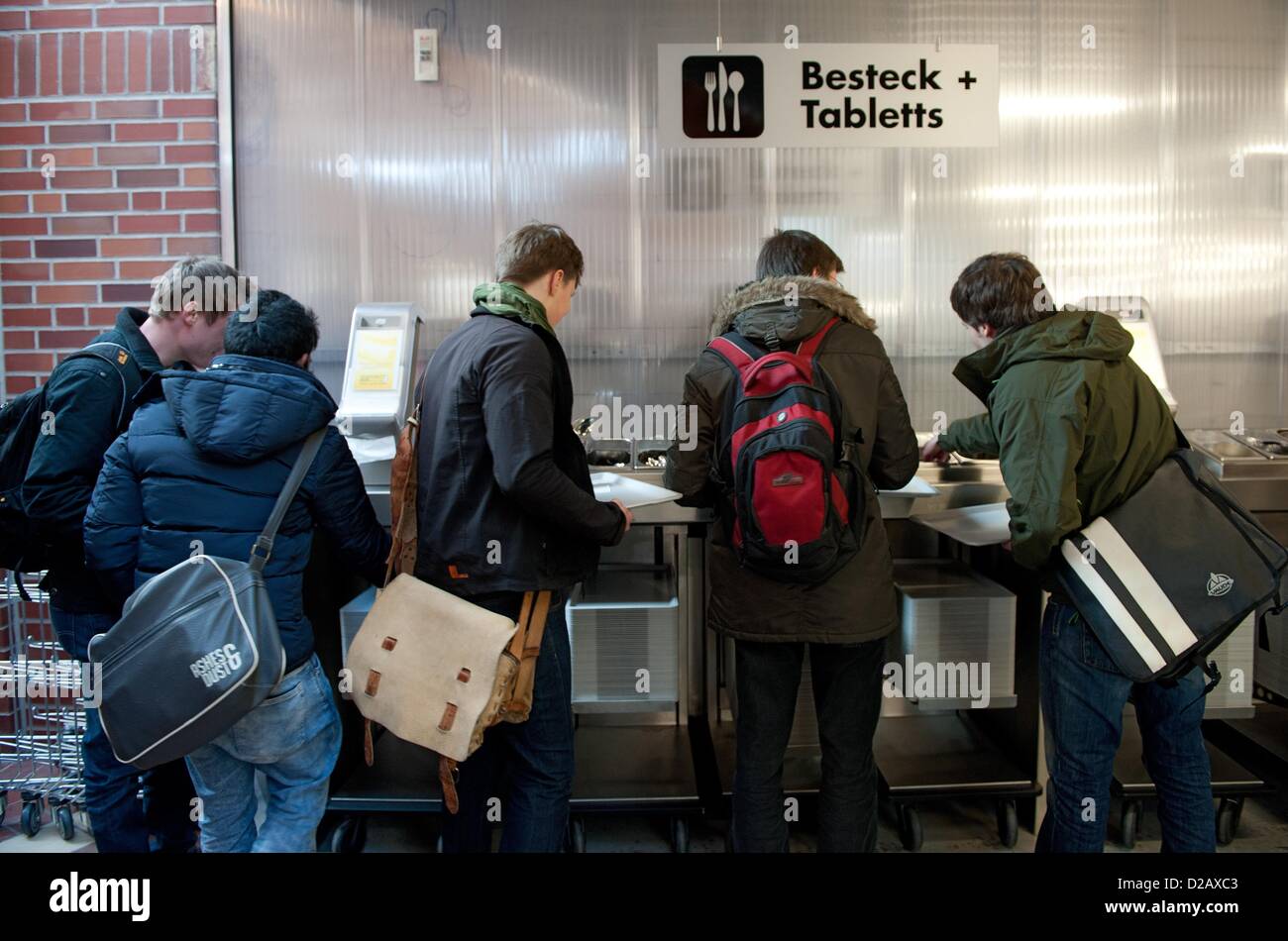 Students queue in line in the refectory of the university in Kassel ...