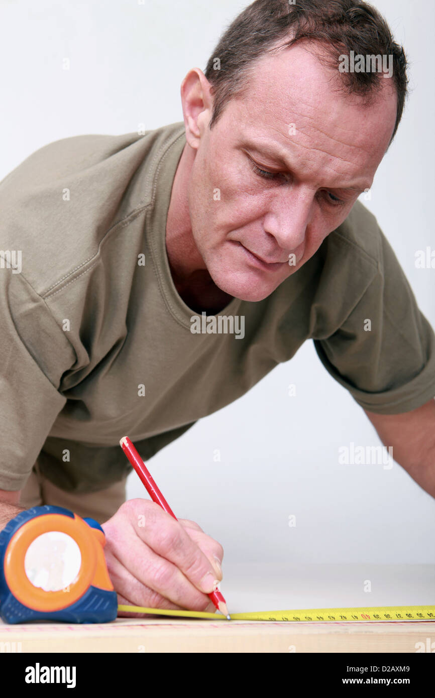 Man measuring wood Stock Photo - Alamy