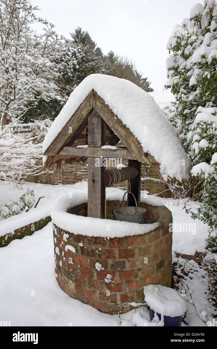 Thatched well covered in snow in a Hampshire garden England UK Stock ...
