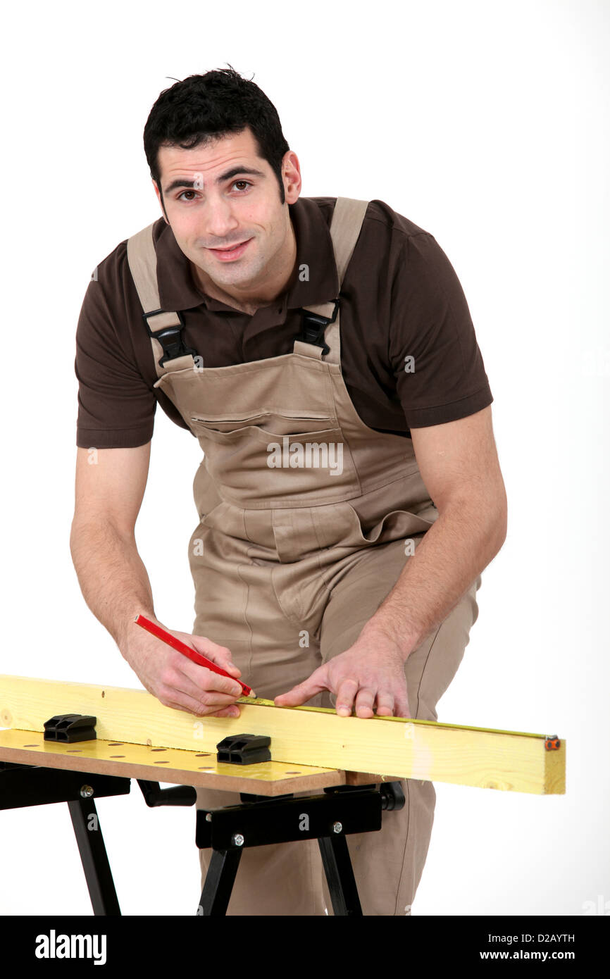 Carpenter measuring wood Stock Photo - Alamy