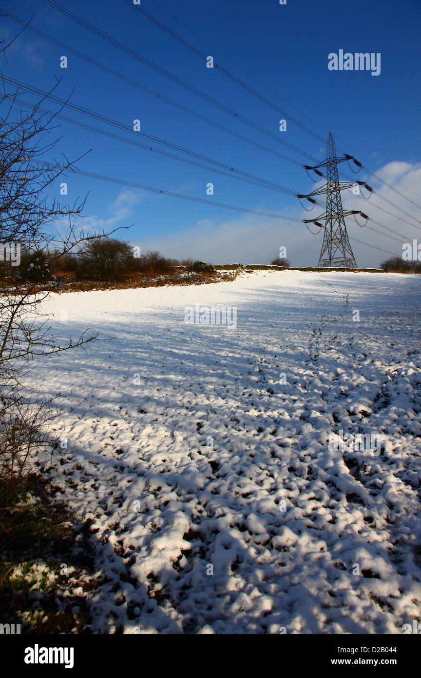 Electricity pylon in snowy landscape Stock Photo - Alamy