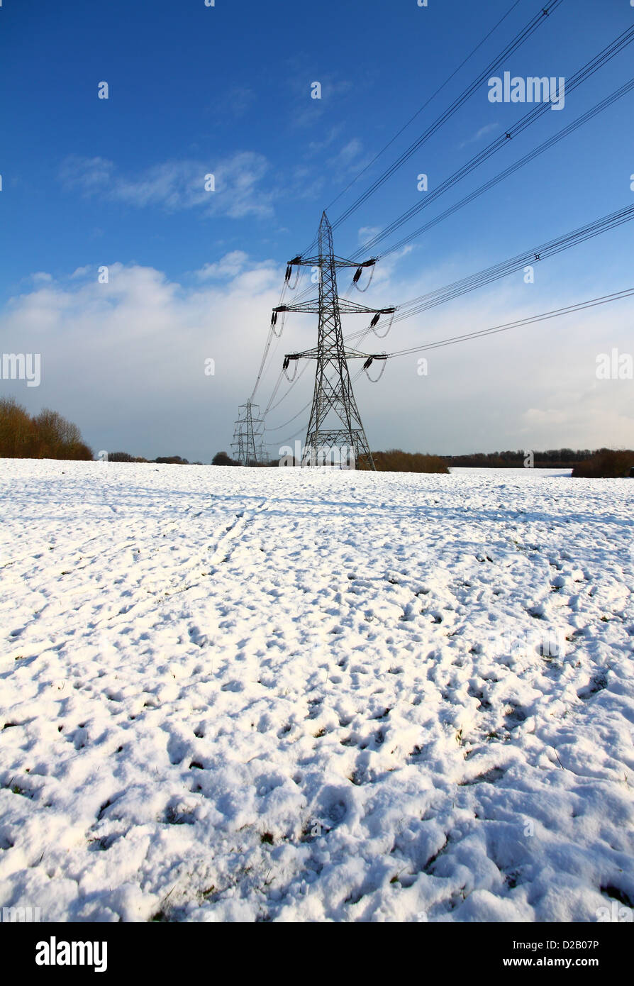 Electricity pylon in snowy landscape Stock Photo - Alamy