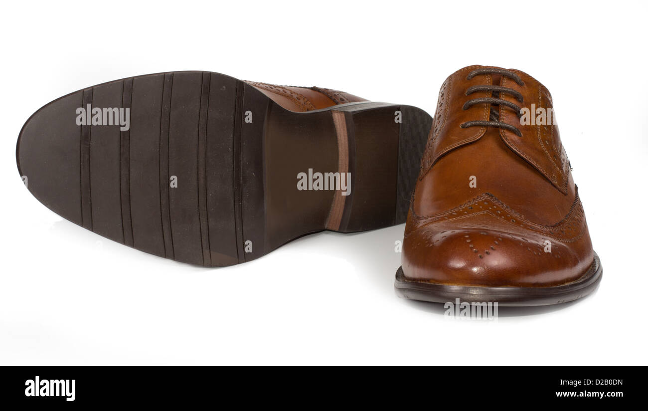 Front view and sole of a pair of elegant classic mens brown leather ...
