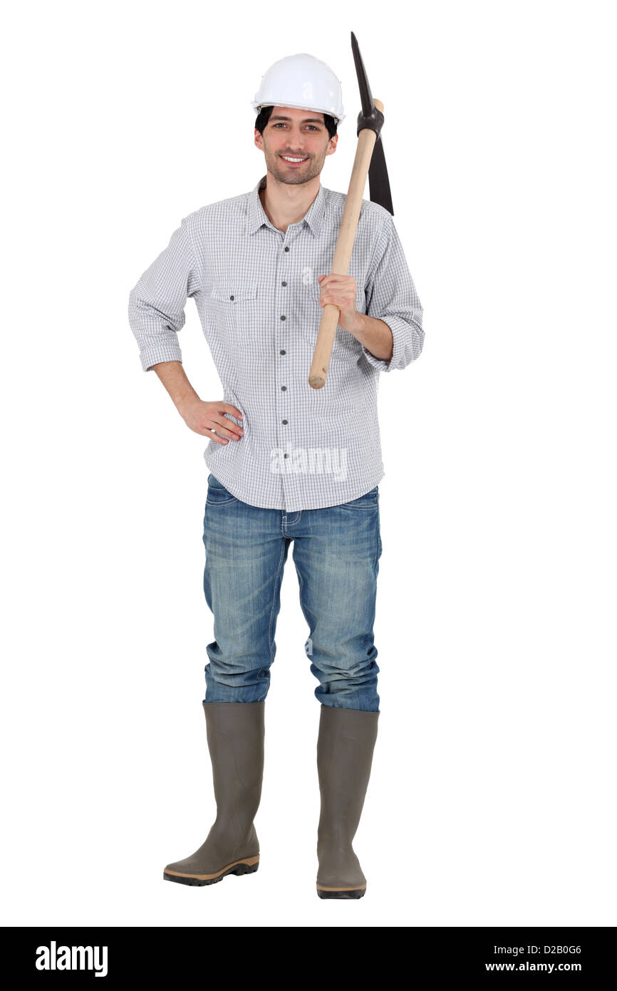 Man holding pick-axe over shoulder Stock Photo - Alamy
