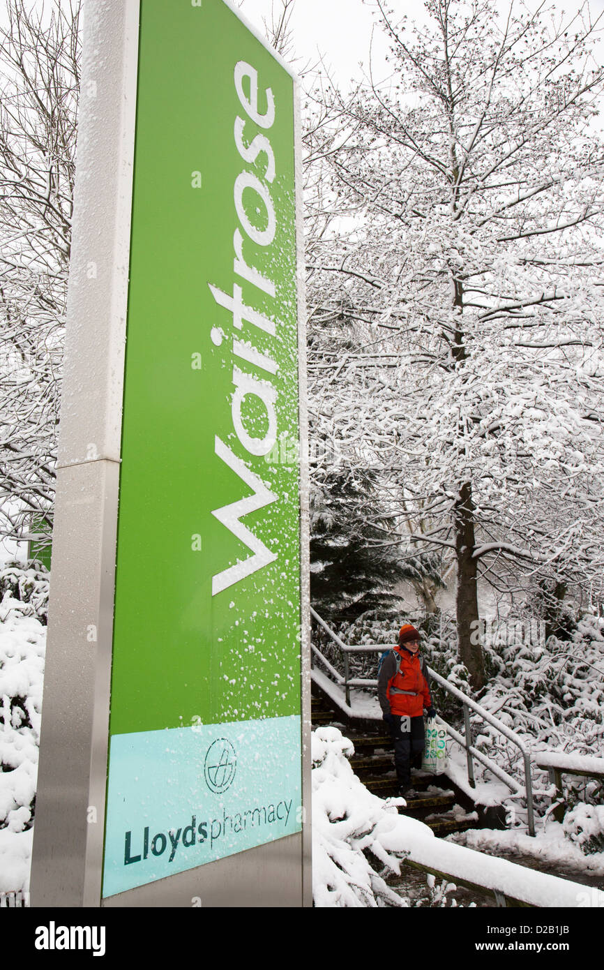 Waitrose supermarket sign with customer walking in snow, Abergavenny ...