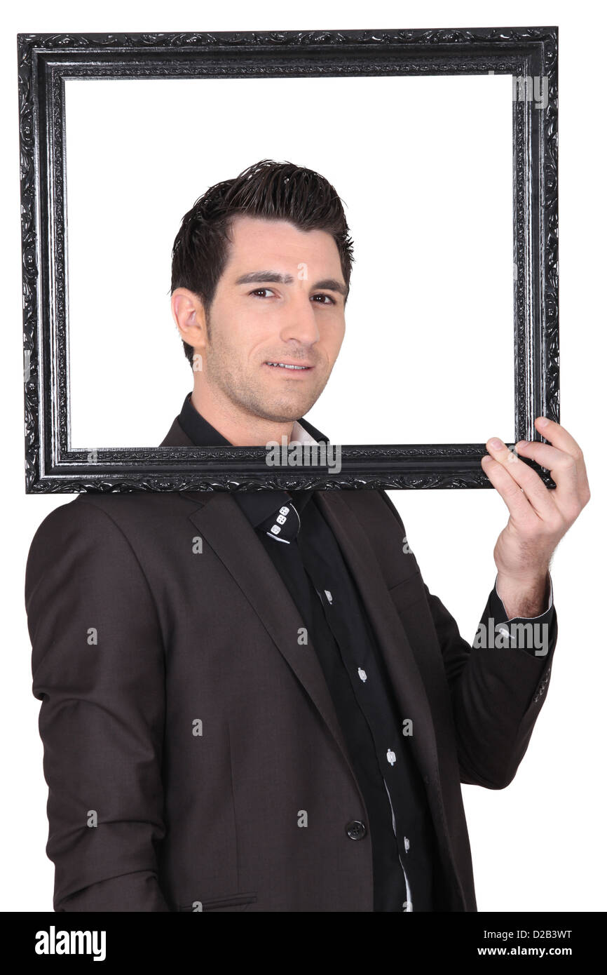 Man posing behind an empty picture frame Stock Photo - Alamy