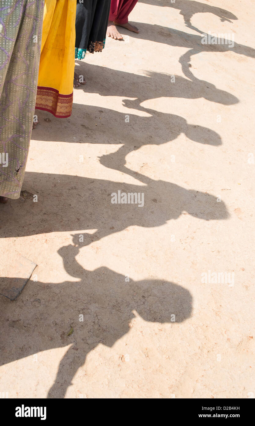 Shadow of Indian village children in a line holding hands playing games ...