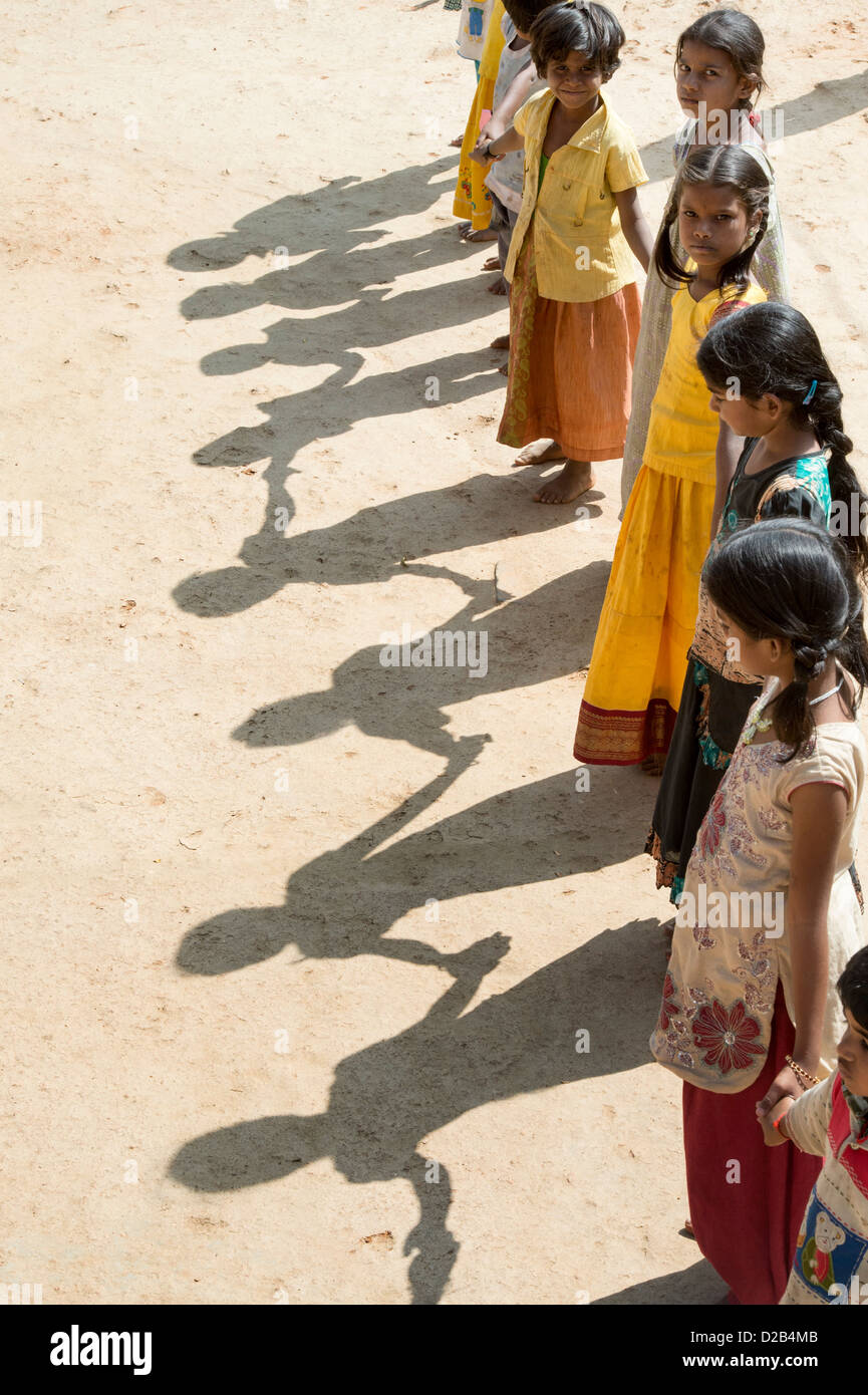 Shadow of Indian village children in a line holding hands playing games ...