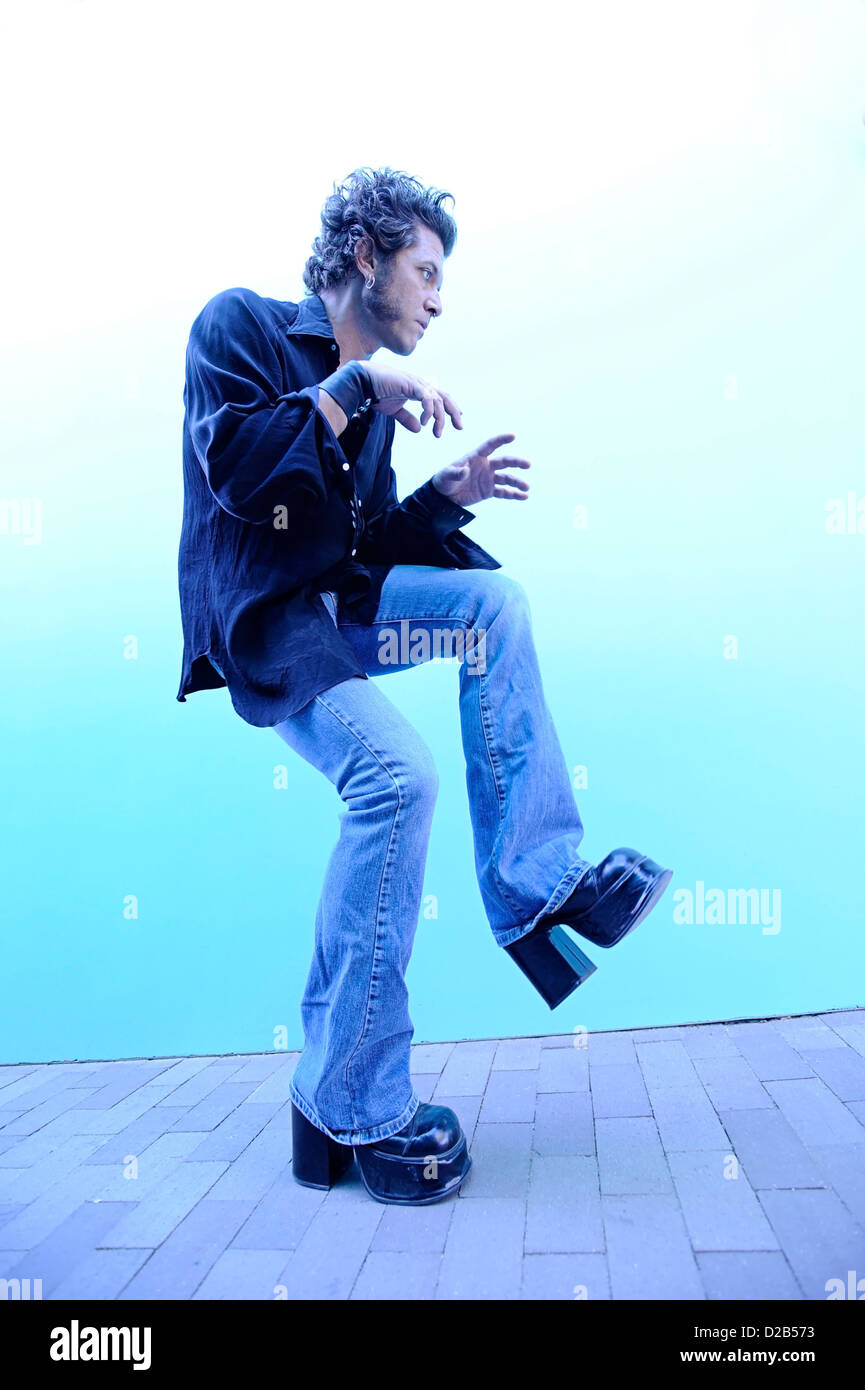 Elevated man stepping out in a strange way Stock Photo - Alamy