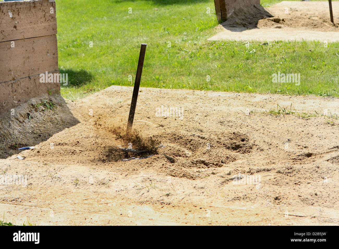 Flying sand as the Horseshoe ringer is made Stock Photo - Alamy