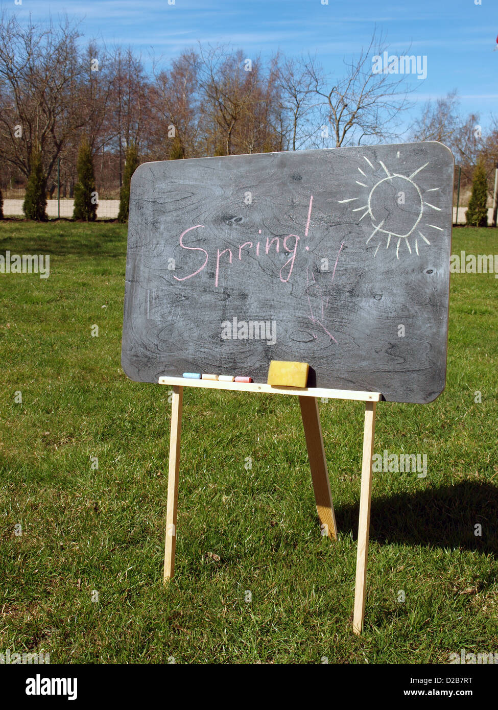 Homemade wooden blackboard outdoor with sun picture and word SPRING ...