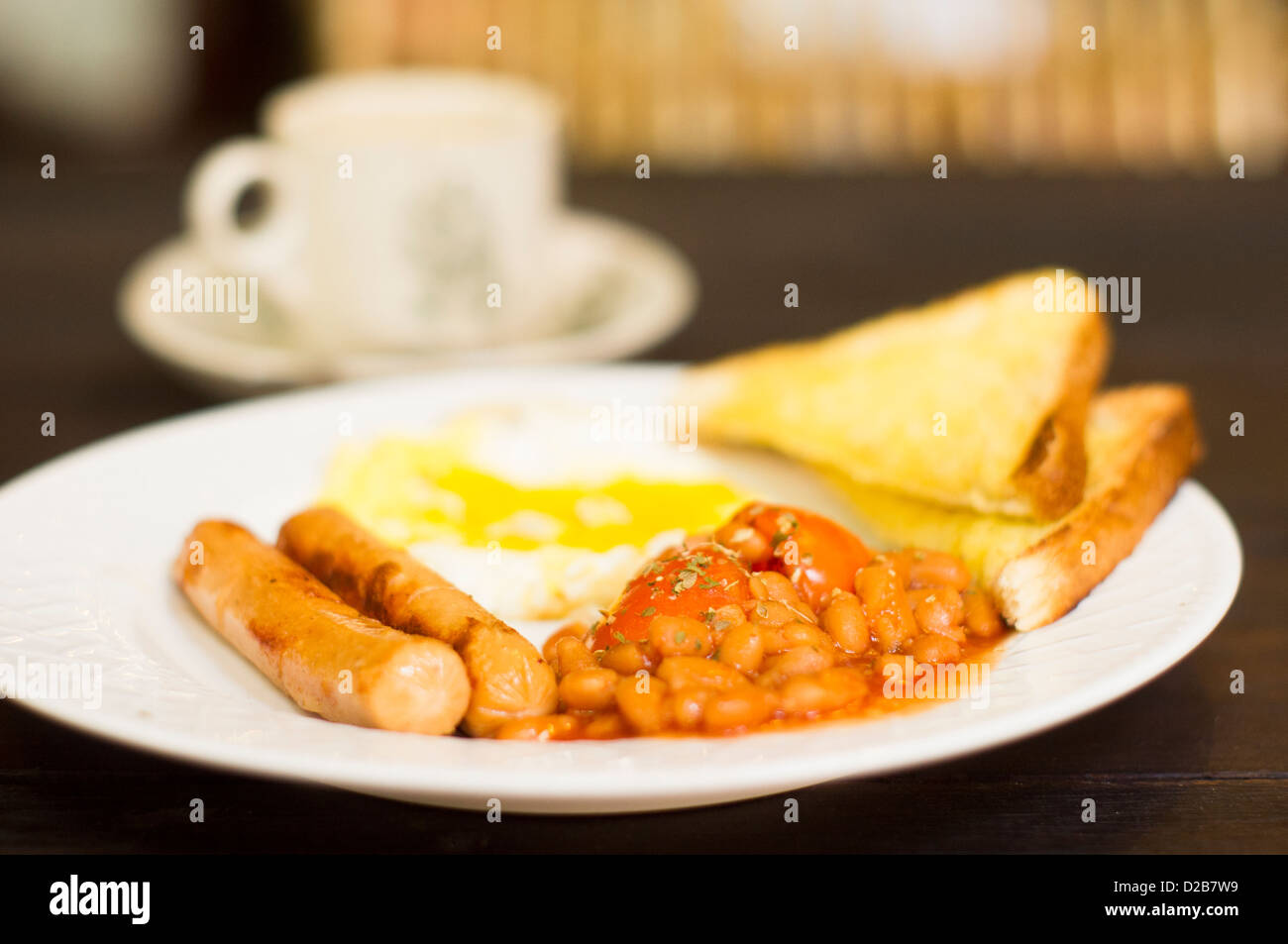 american or western breakfast, sausages, fried egg, beans and toasts ...