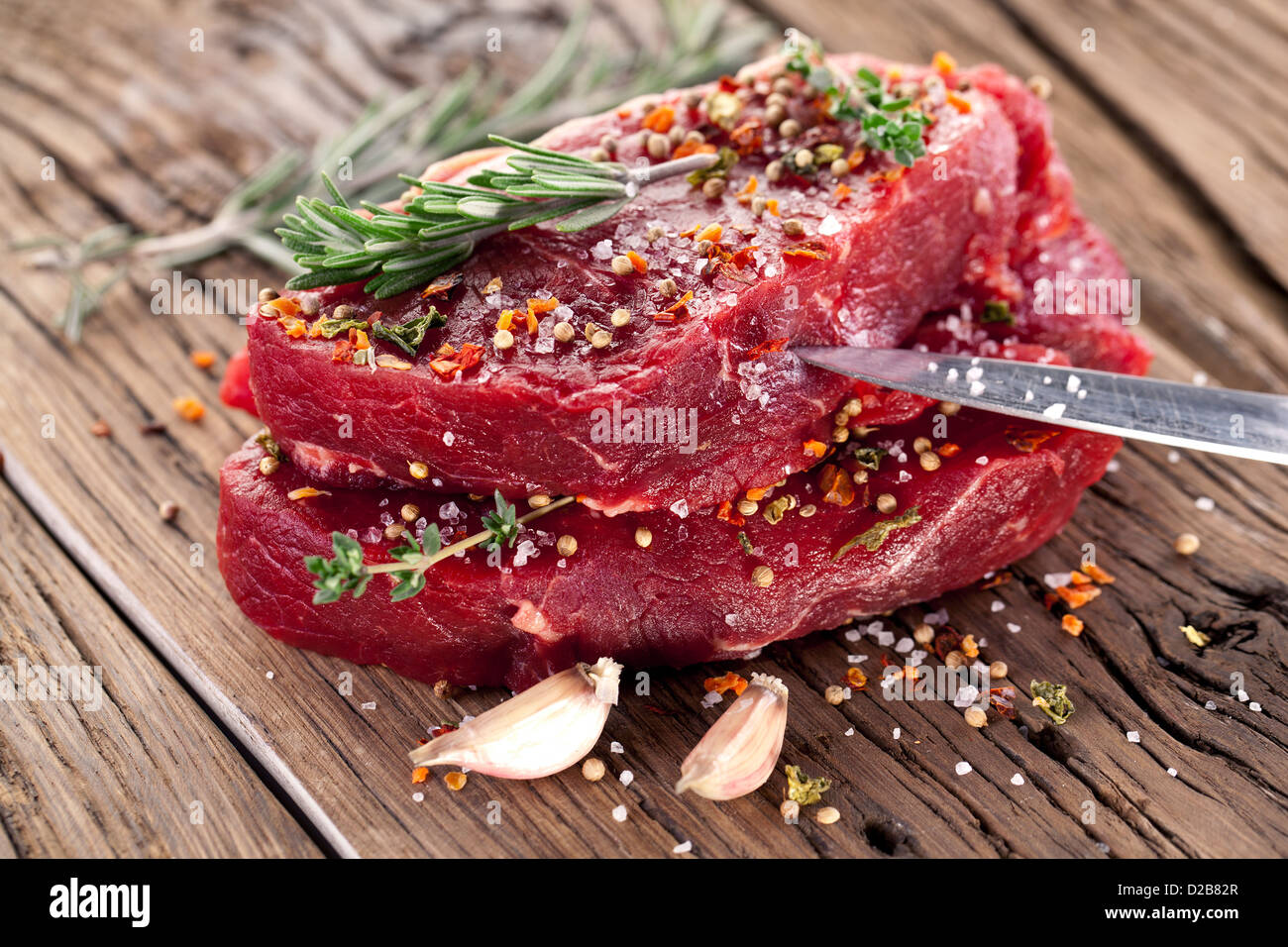 Raw beef steak on a dark wooden table Stock Photo - Alamy