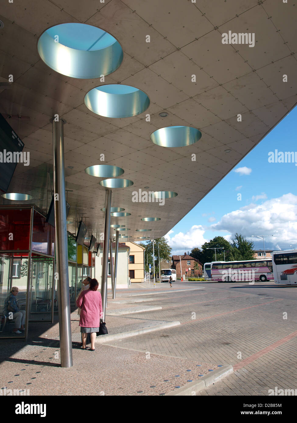 Bus stop covered by modern roof with round roof windows Stock Photo - Alamy