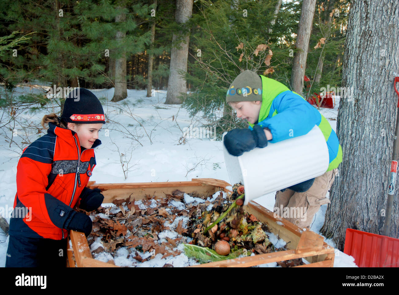 Girls Dumping Food Scraps Into Compost Bin Stock Photo - Alamy