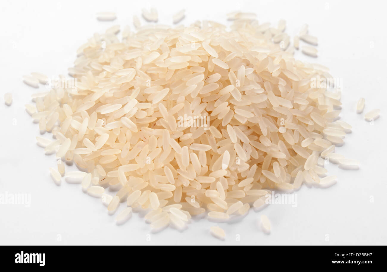 Handful of rice on a white background Stock Photo - Alamy