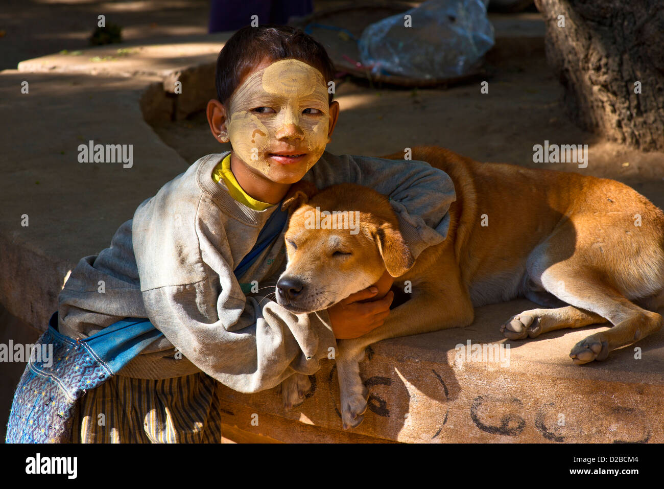 Burmese boy with dog, Bagan, Myanmar, Burma Stock Photo - Alamy
