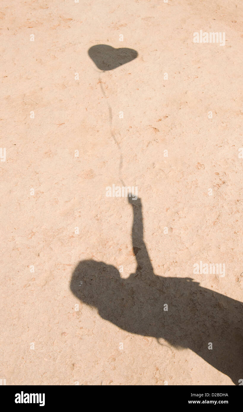 Shadow of an Indian girl holding a heart shaped balloon. India Stock ...