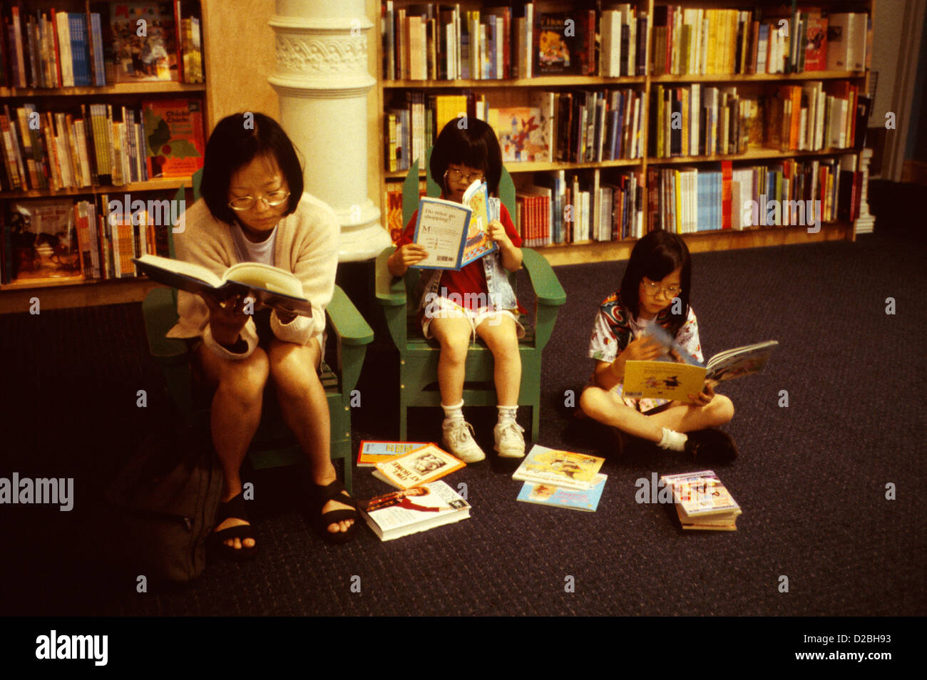 New York City, Manhattan. Mother W/ 2 Daughters Reading & Shopping For ...