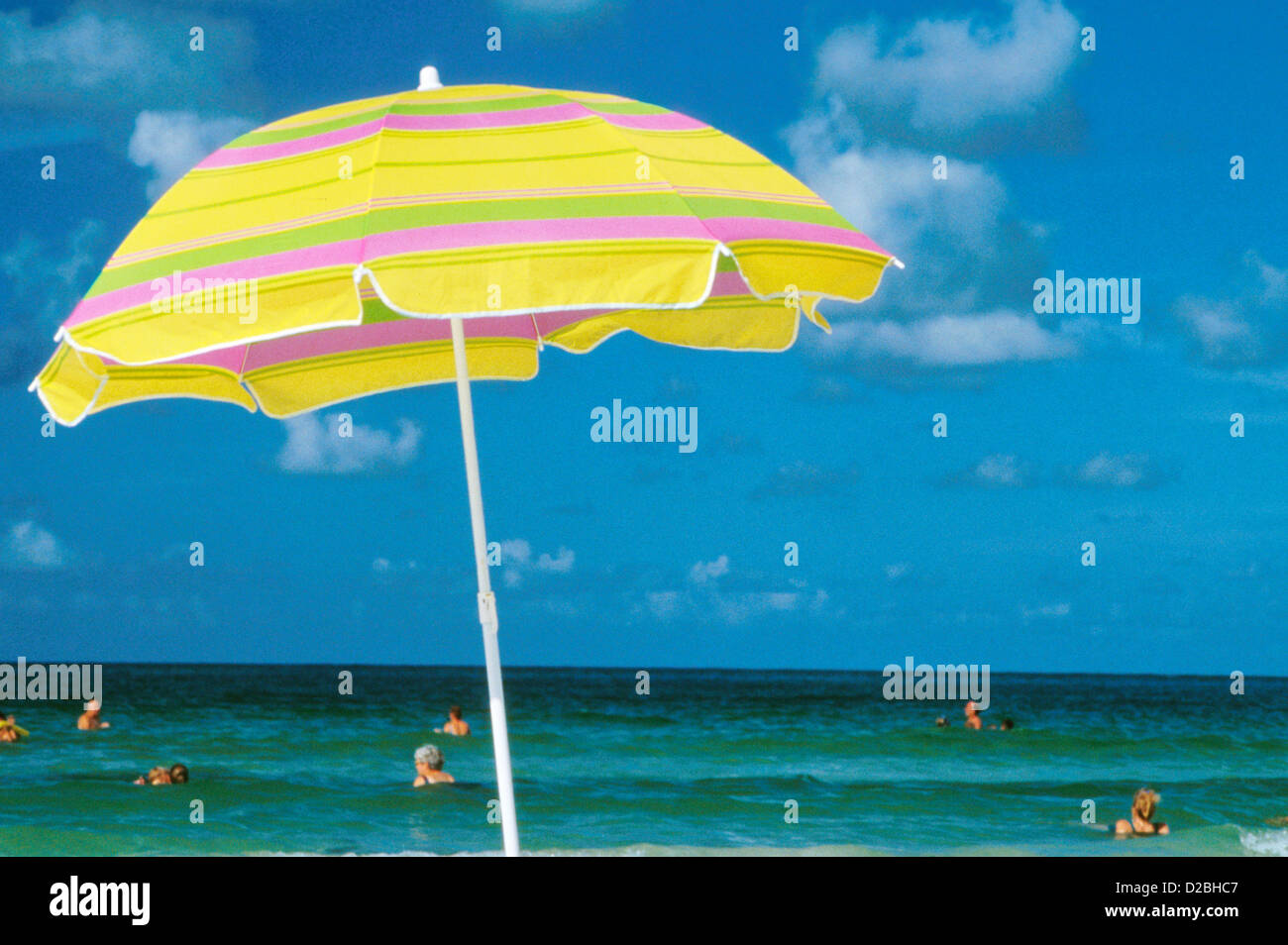 Yellow beach umbrella against ocean people hi-res stock photography and ...