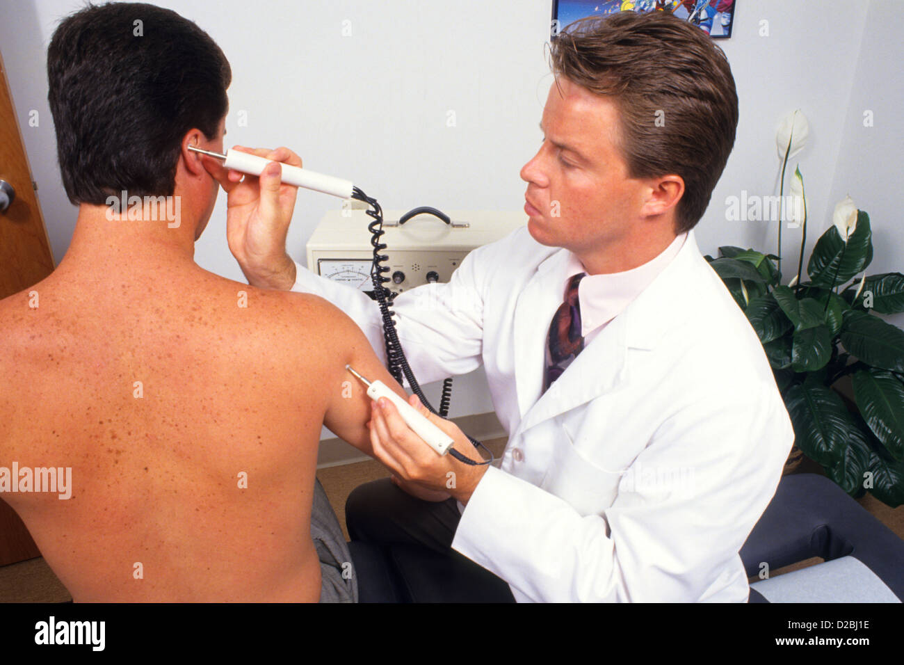 Doctor performing electrical accupunture hi-res stock photography and ...