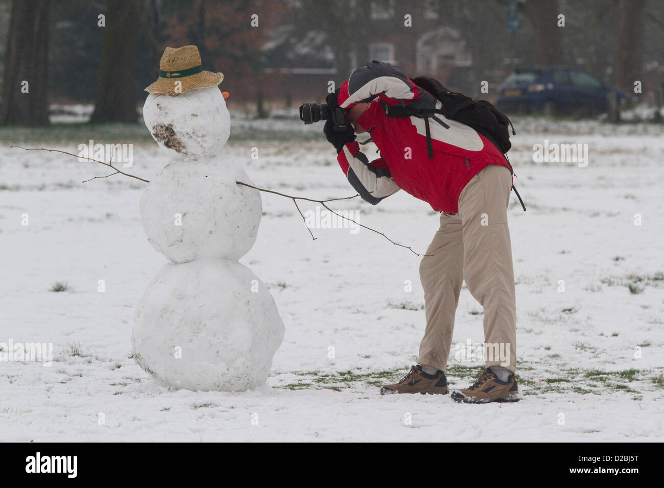 19th January 2013. A man photographs a snow man on wimbledon common ...