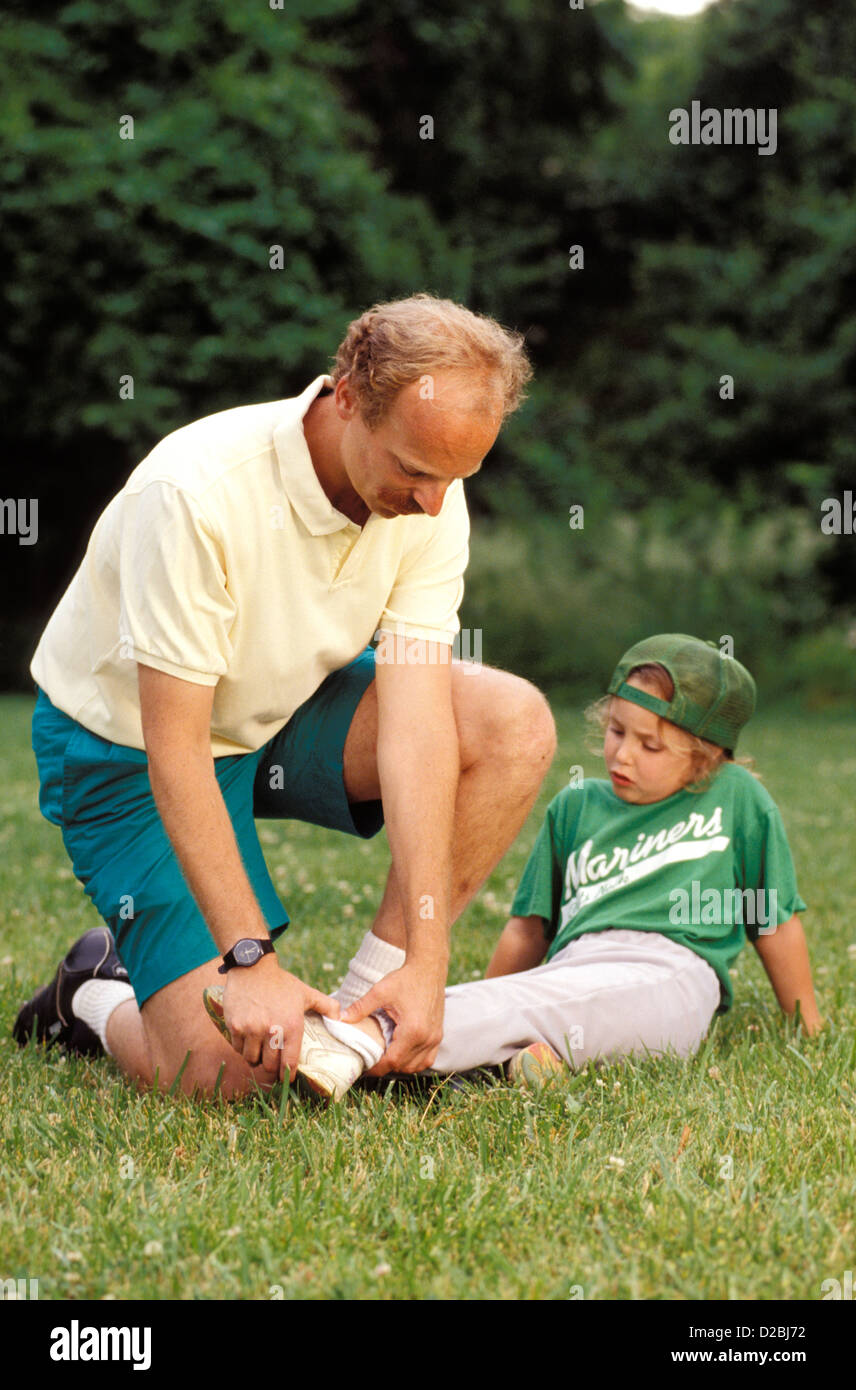 Girl being checked for sprained ankle hi-res stock photography and ...
