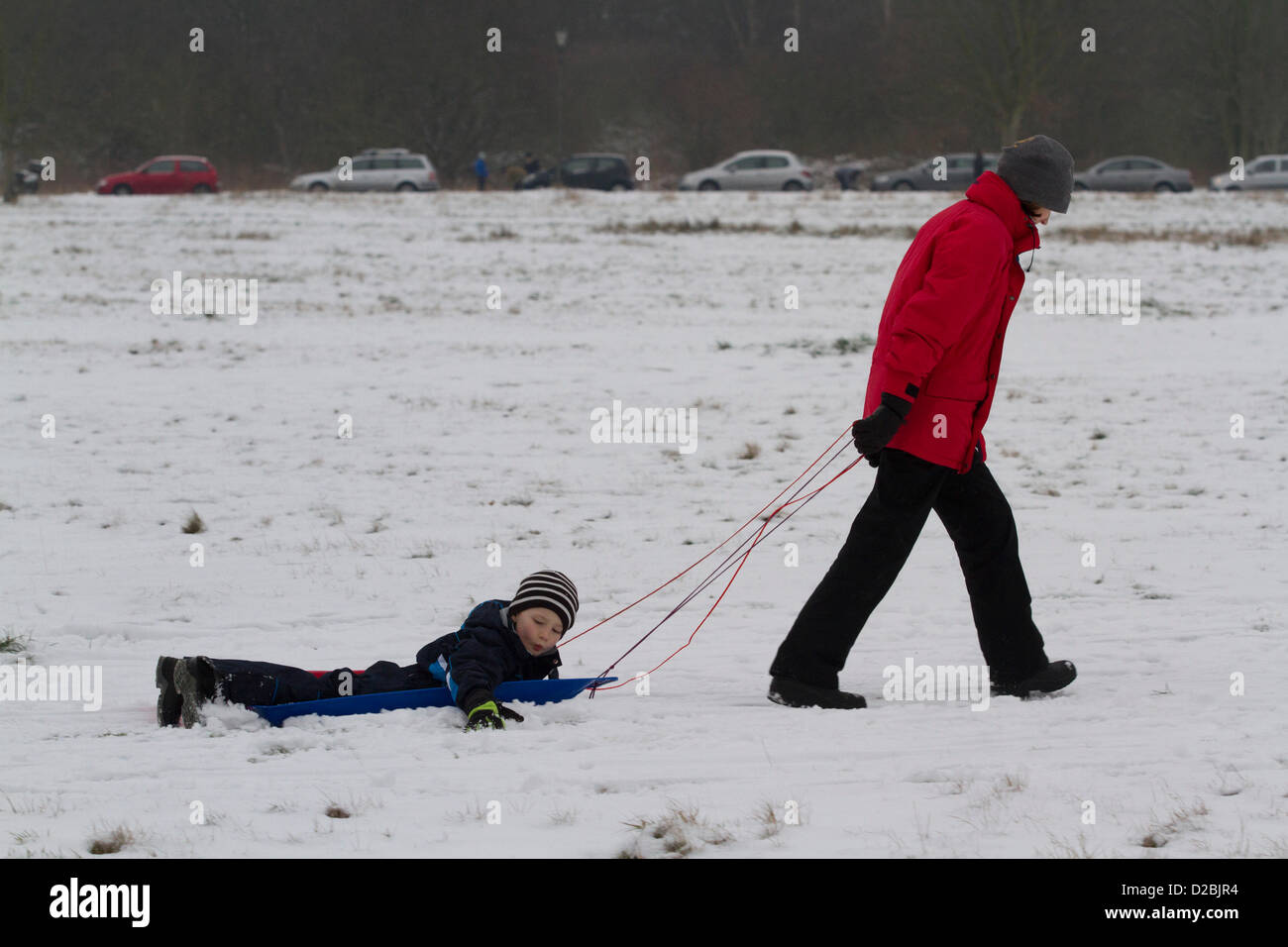 19th January 2013. A parent pulls a child on a sledge on Wimbledon ...
