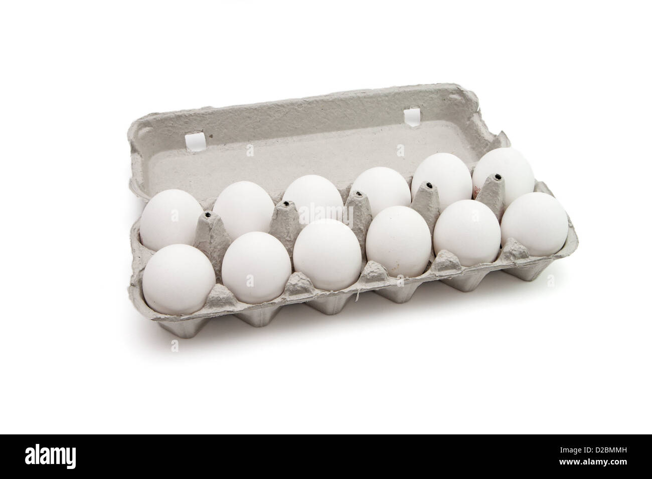 Twelve eggs in a paper box on white background Stock Photo - Alamy