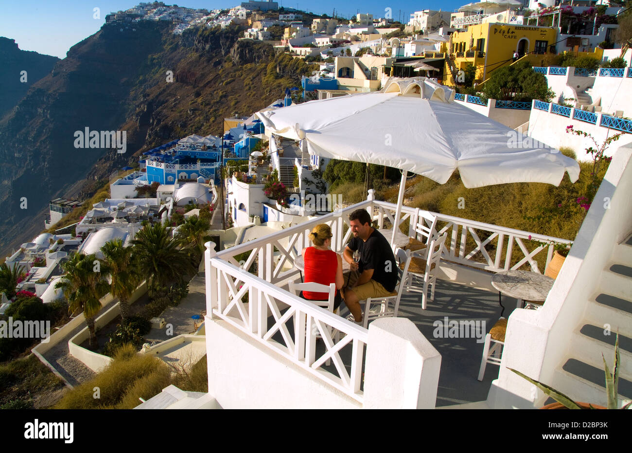 Santorini, Greece. Fira. Couple Relaxing On Terrace Stock Photo - Alamy