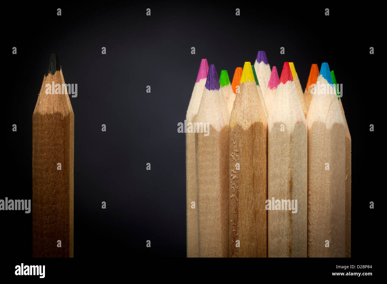 Isolation concept - black pencil standing apart from group of colored ...