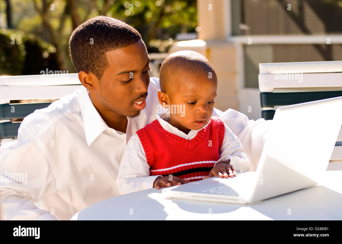 Father With Young Boy Using Computer Stock Photo - Alamy