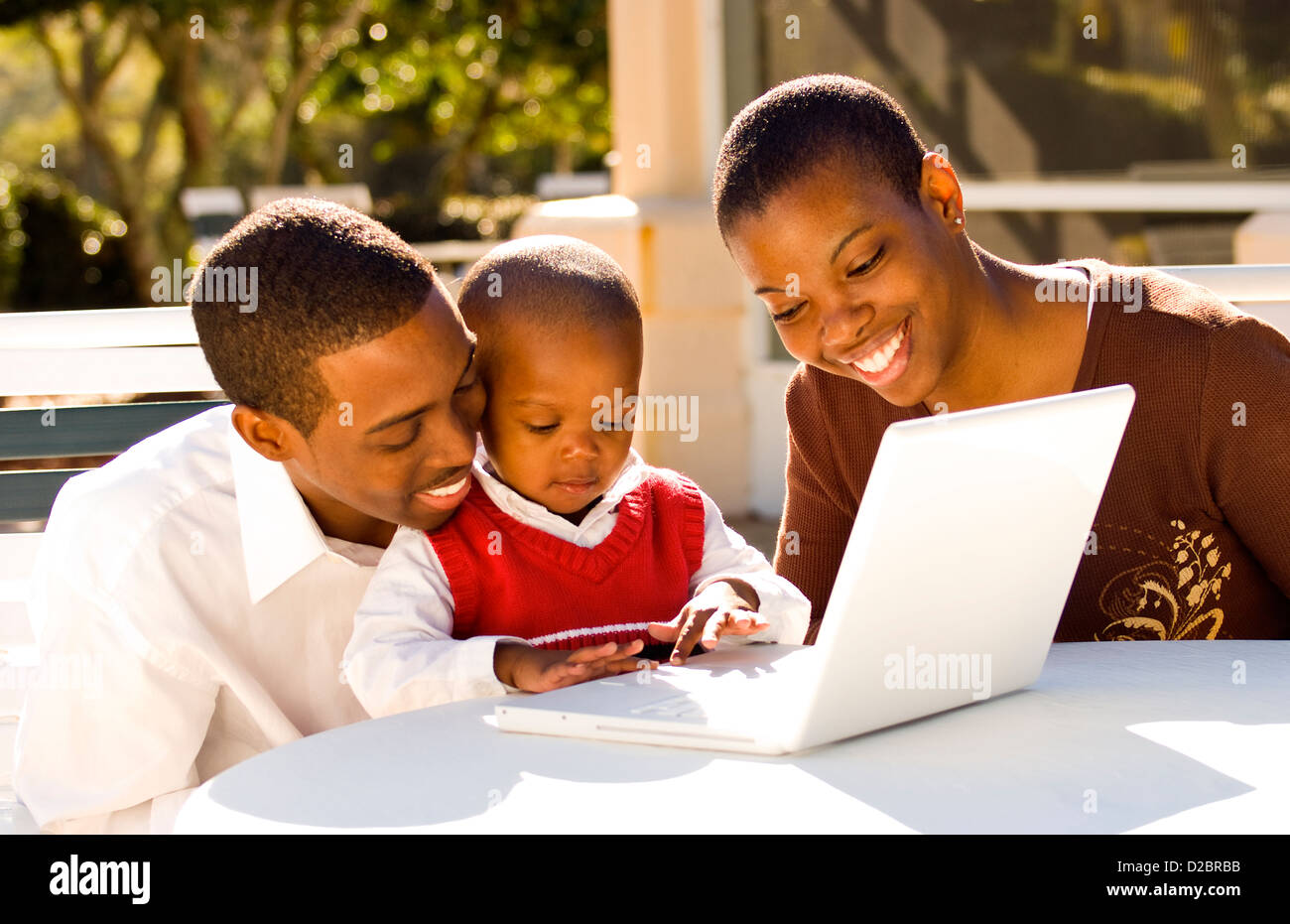 Family Outdoors Using Laptop Computer Stock Photo - Alamy