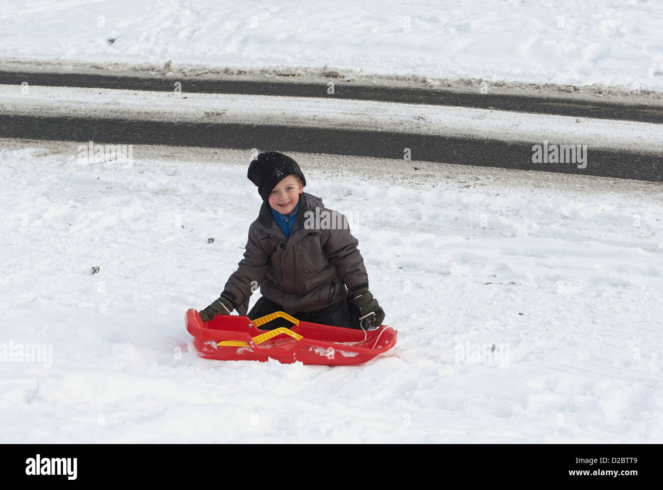 Child Boy (6-8) on a bob sledge, snow, wintertime Stock Photo - Alamy
