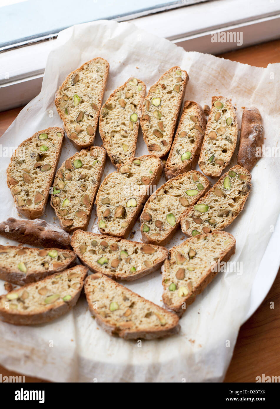 Home baked biscotti on a baking tray fresh from oven cooling by a ...