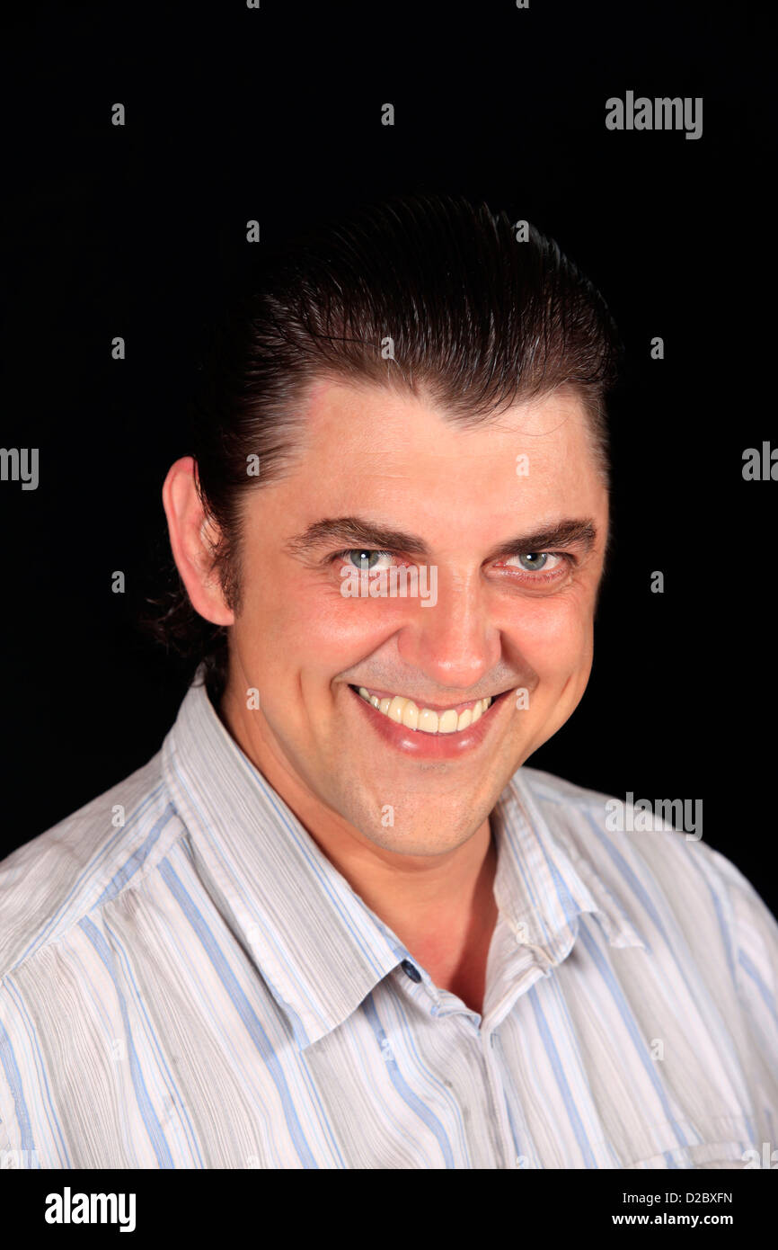 Adult business man posing against black background Stock Photo - Alamy