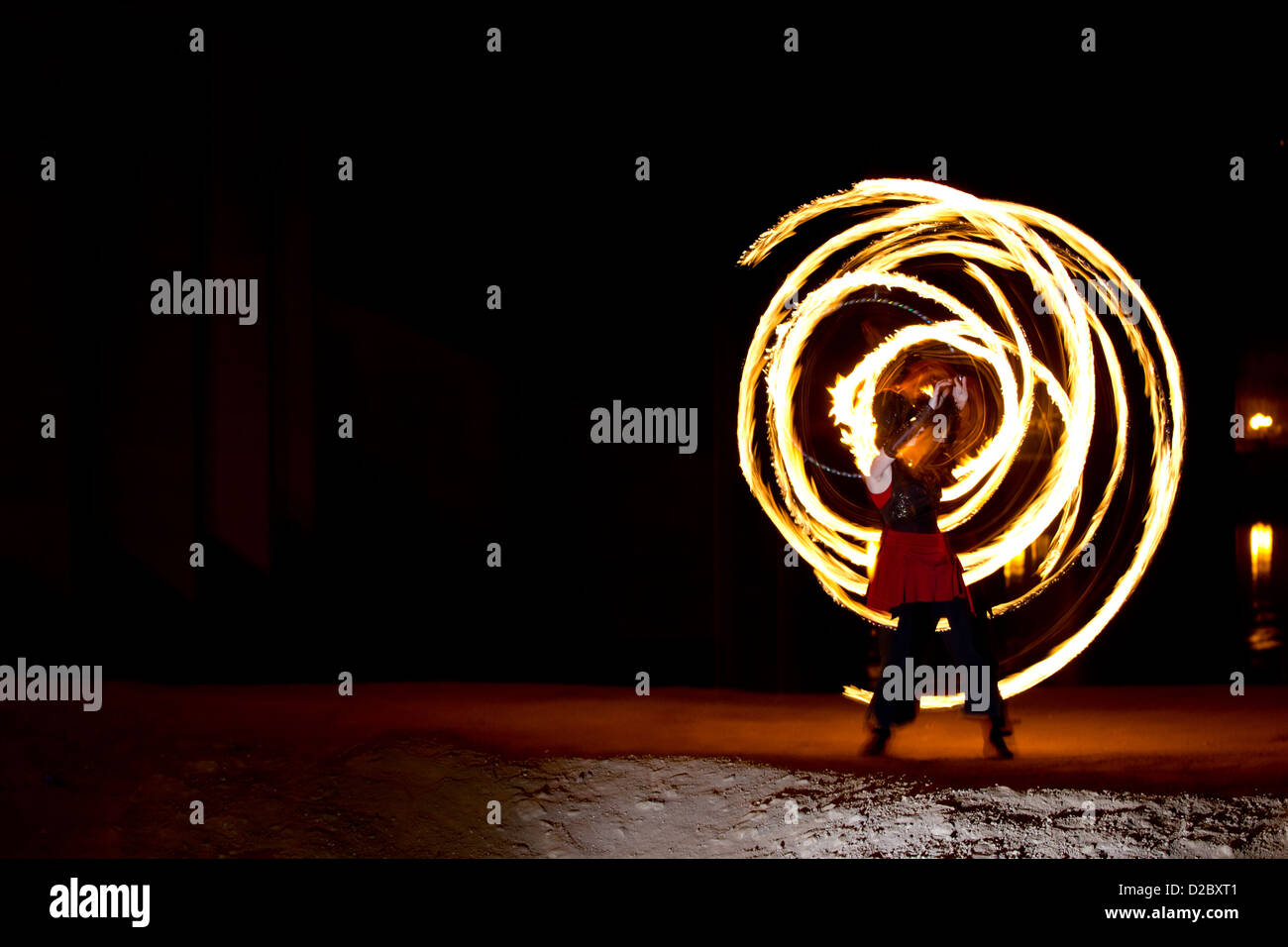 Fire spinners using fire hula hoops Stock Photo - Alamy