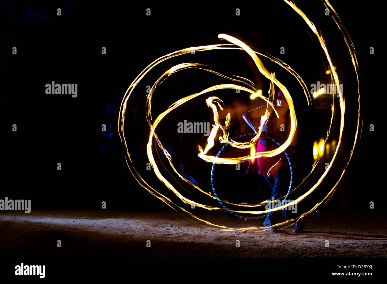 Fire spinners using fire hula hoops Stock Photo - Alamy