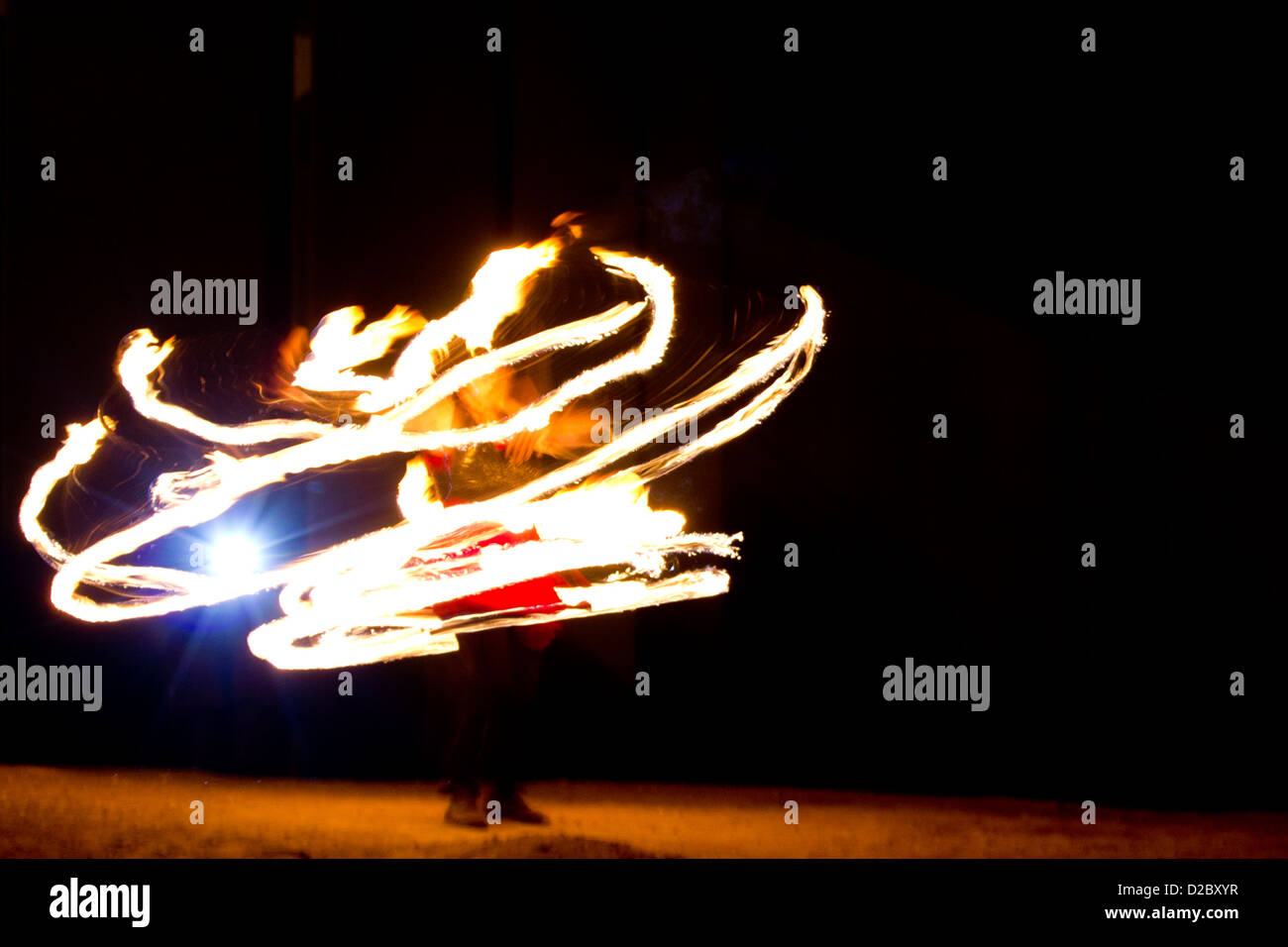 Fire spinners using fire hula hoops Stock Photo - Alamy