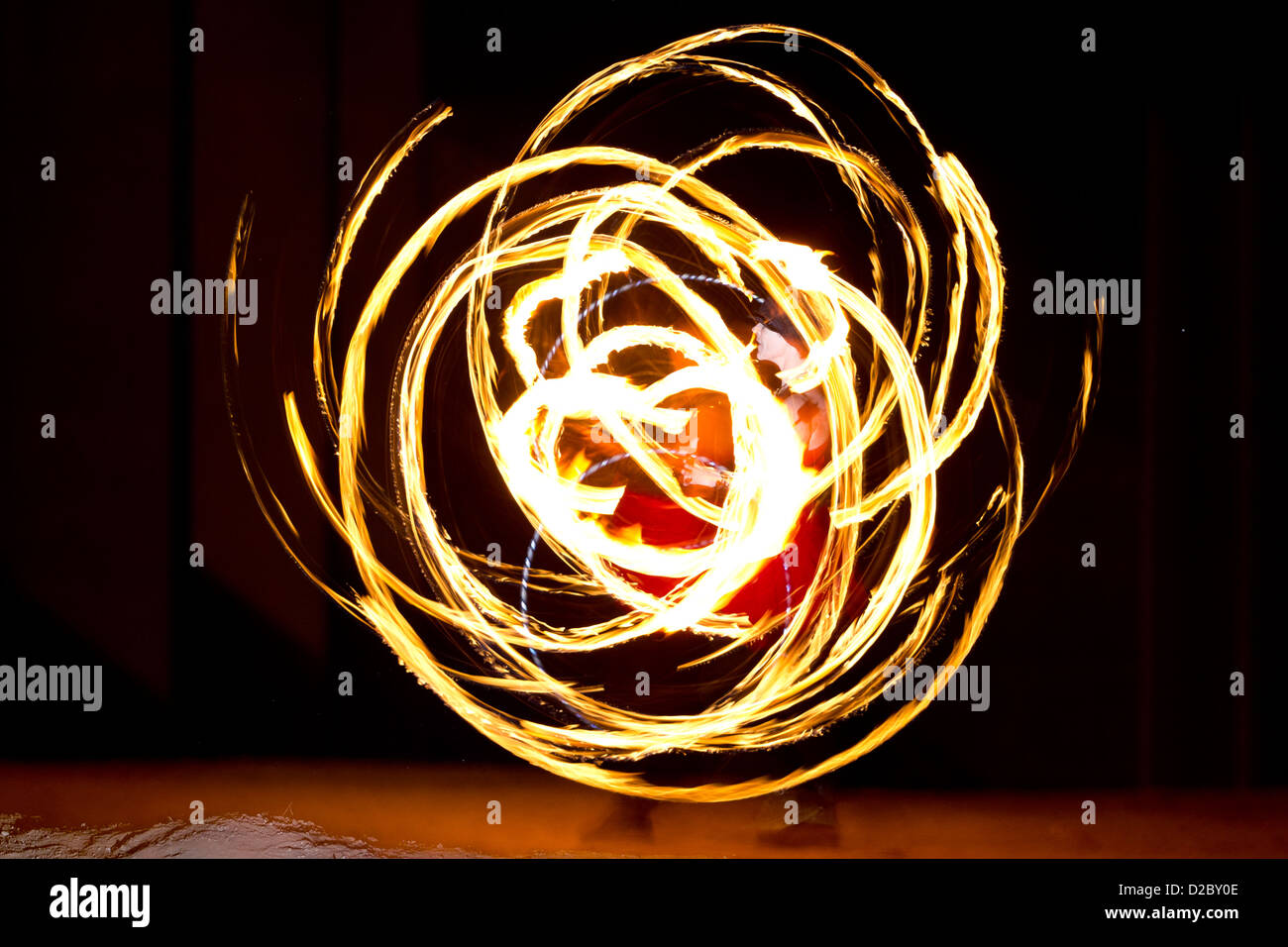 Fire spinners using fire hula hoops Stock Photo - Alamy