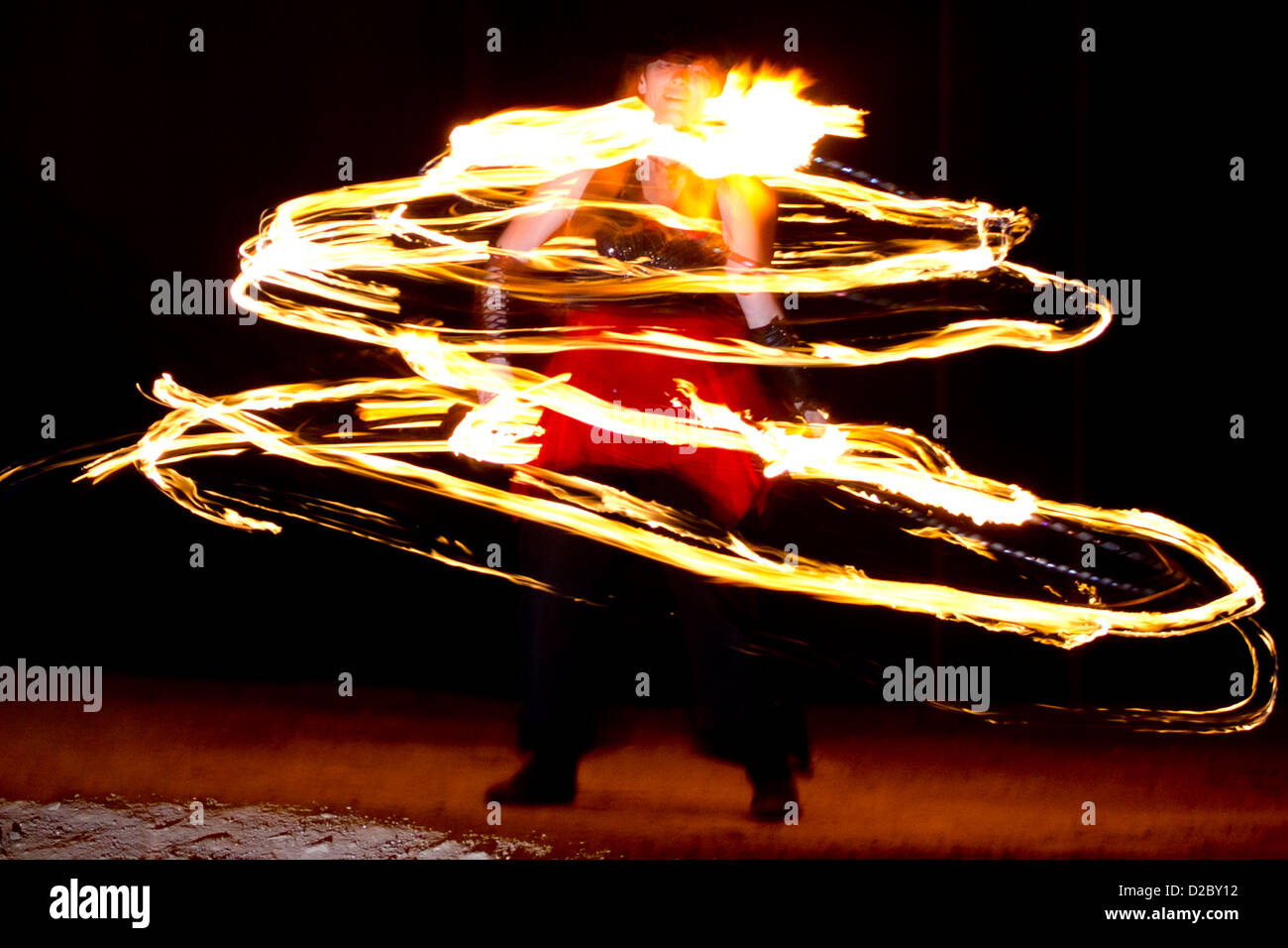 Fire spinners using fire hula hoops Stock Photo - Alamy