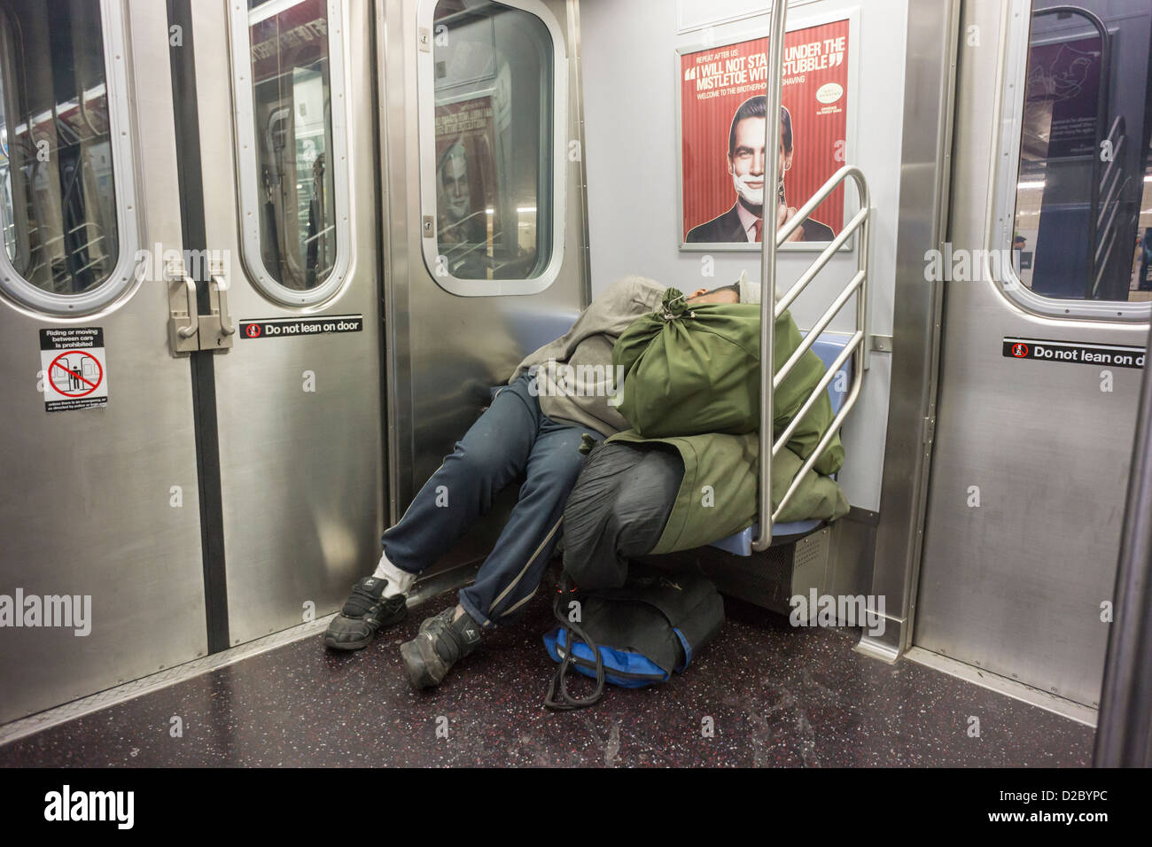 Homeless man escapes the cold and sleeps in a subway car in New York on ...