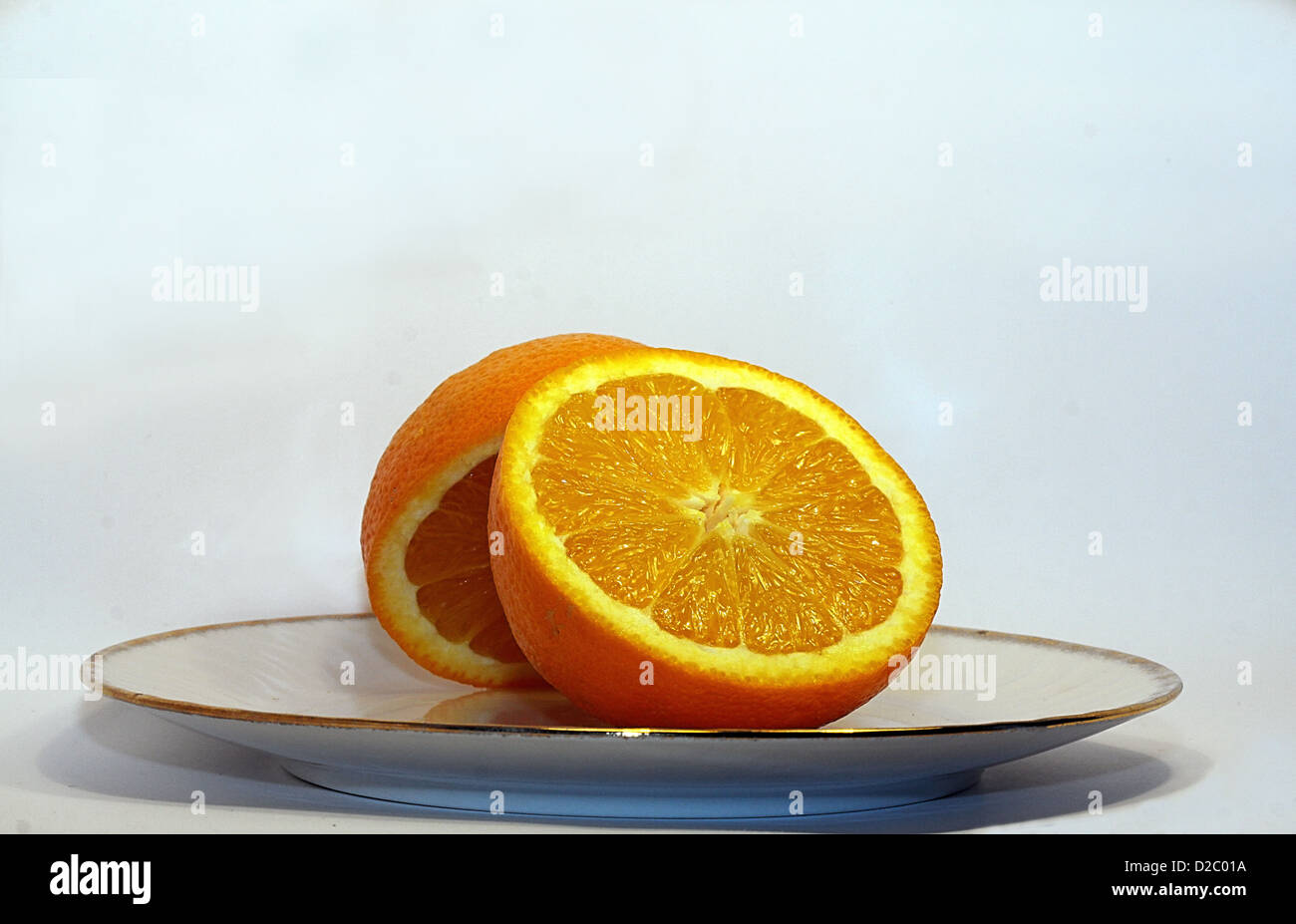 Two slices of orange on plate Stock Photo - Alamy