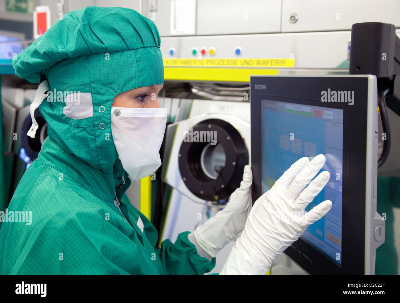 Duisburg, Germany, a micro technologist working in the clean room at ...