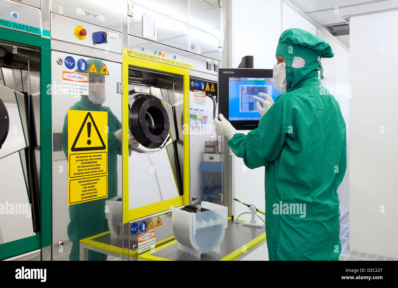 Duisburg, Germany, a micro technologist working in the clean room at ...