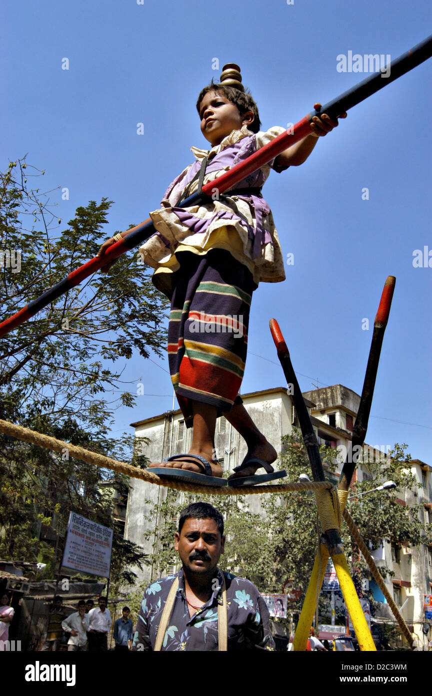 South Asian Girl Working Street Performer Balancing Act By Walking On ...
