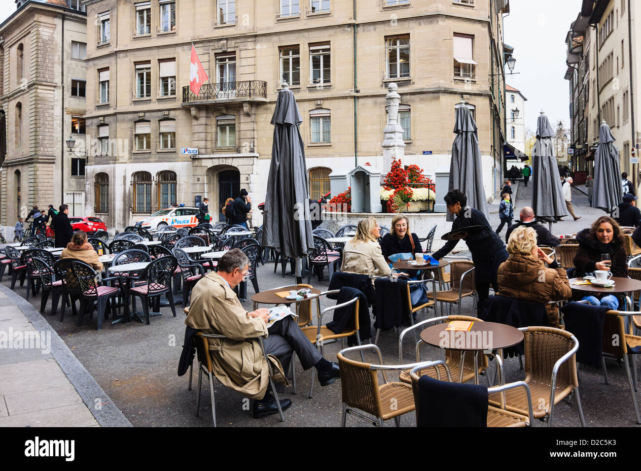 People sitting at the terrace cafes of Place du Bourg-de-Four, Geneva’s ...